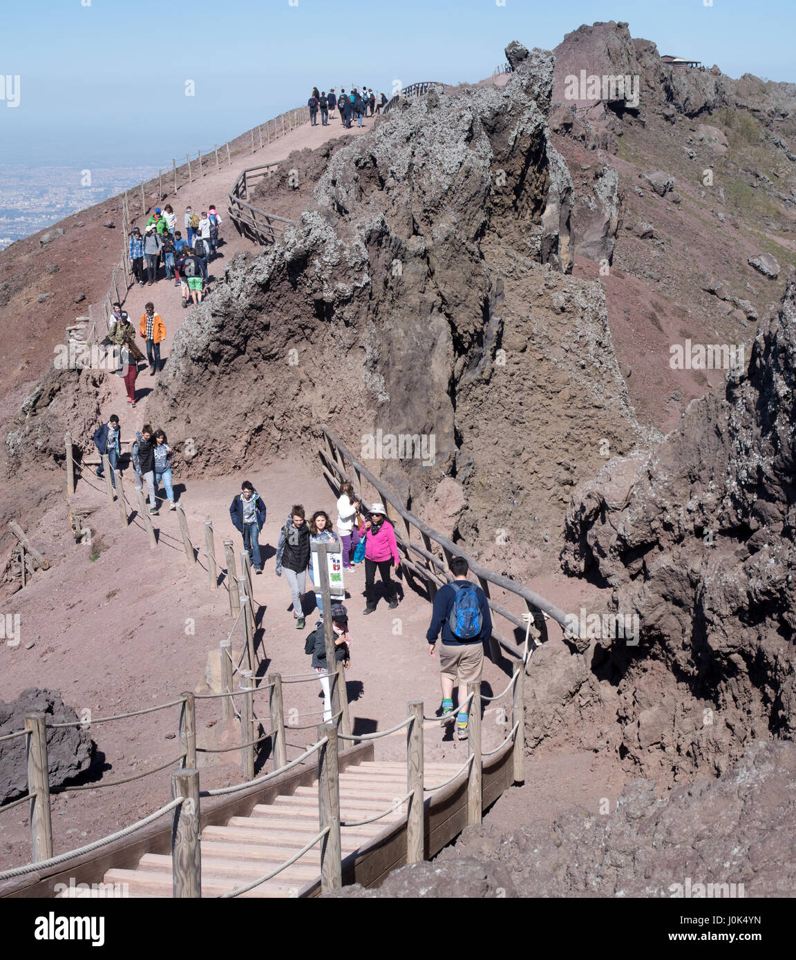 Tourists walk by the rim of the crater of Mount Vesuvius in Campania ...