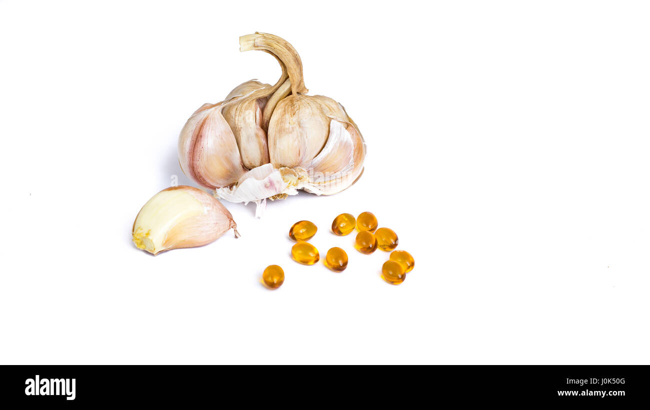 Organic garlic and garlic capsule in front of white background Stock ...
