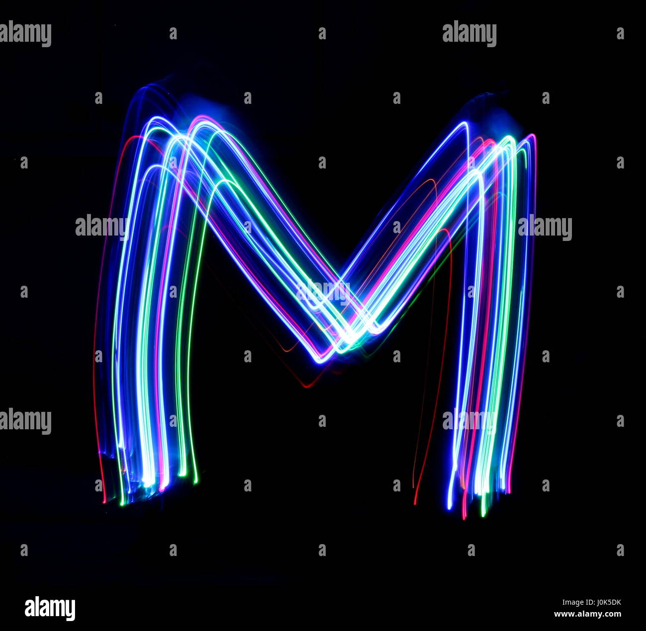 Long exposure photograph of neon multi-colour in an abstract letter M ...