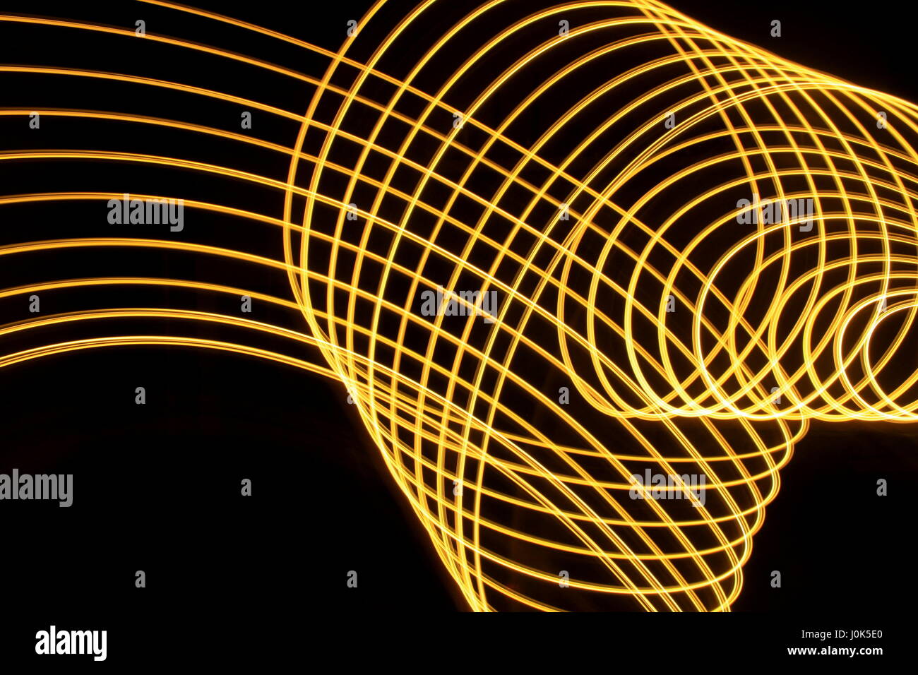 Long exposure photograph of neon gold colour in an abstract pattern ...