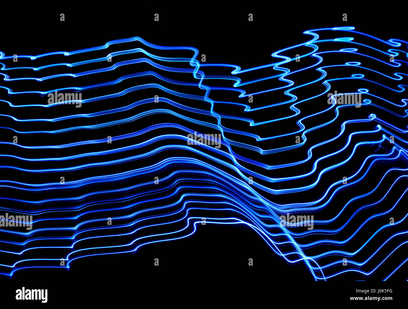 Long exposure photograph of neon electric blue colour in an abstract ...