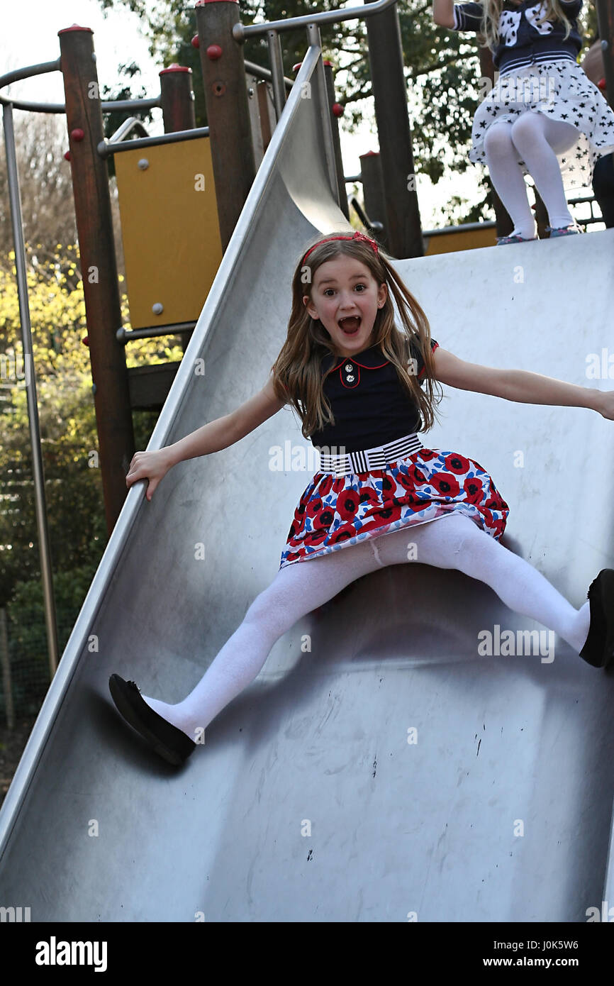 Child, kid sliding down a slide, screaming with excitement, Herbert ...