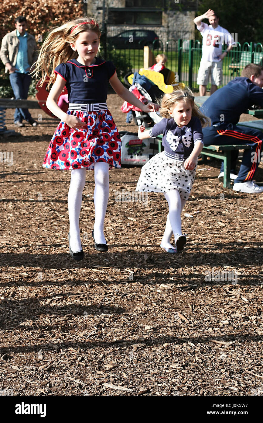 Children, kids playing and climbing in a playground in summer Ireland ...