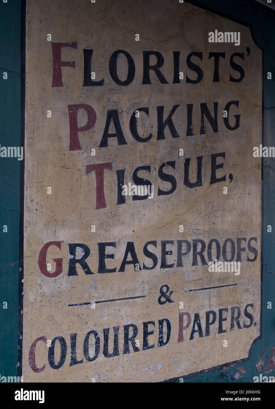 Old 1930s commercial signs on a wall by Spitalfields Church in the City ...