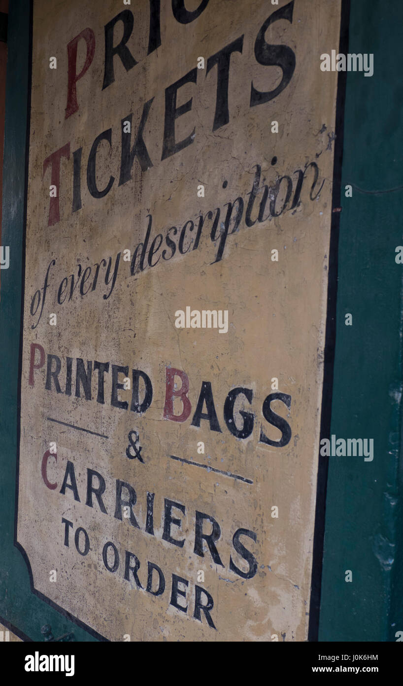 Old 1930s commercial signs on a wall by Spitalfields Church in the City ...