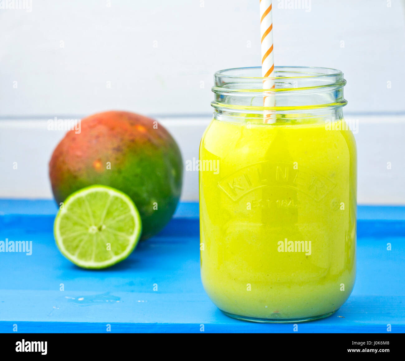Mango lime smoothie in jar Stock Photo - Alamy