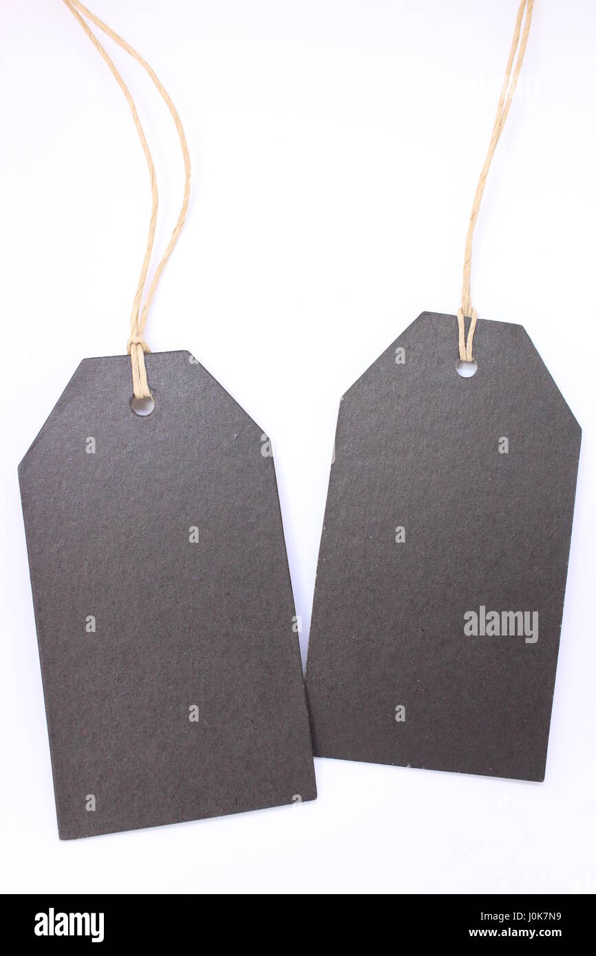 A photograph of two black paper price tags with string, for prices ...
