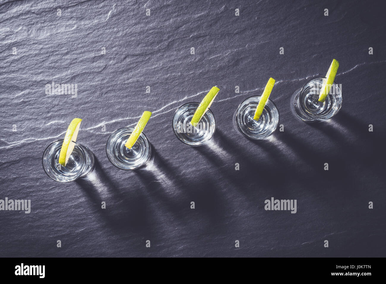 Overhead shot of vodka glasses on dark stone table Stock Photo - Alamy