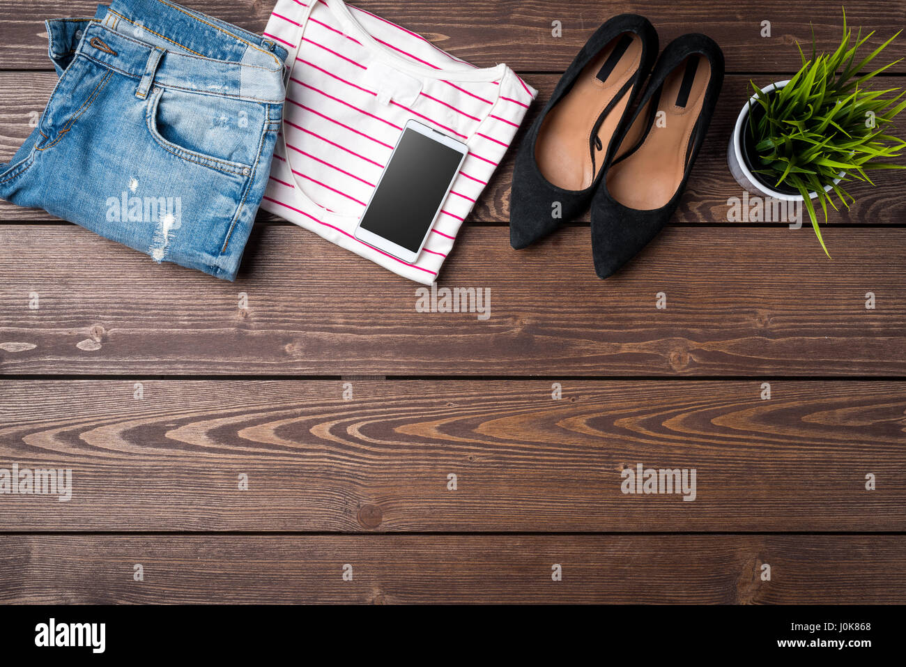 Female clothes on wooden table Stock Photo - Alamy