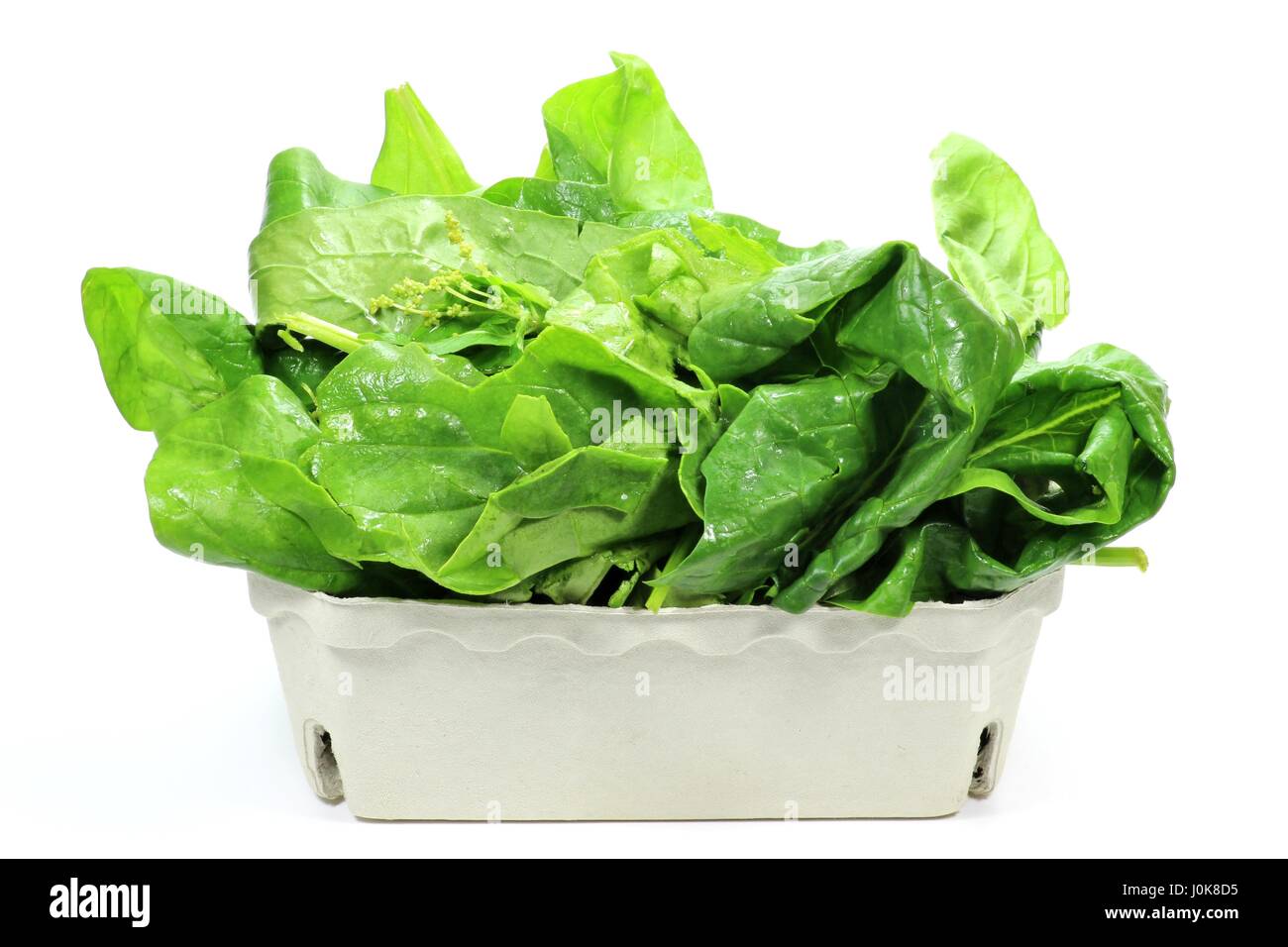 fresh spinach in a cardboard container isolated on white background ...