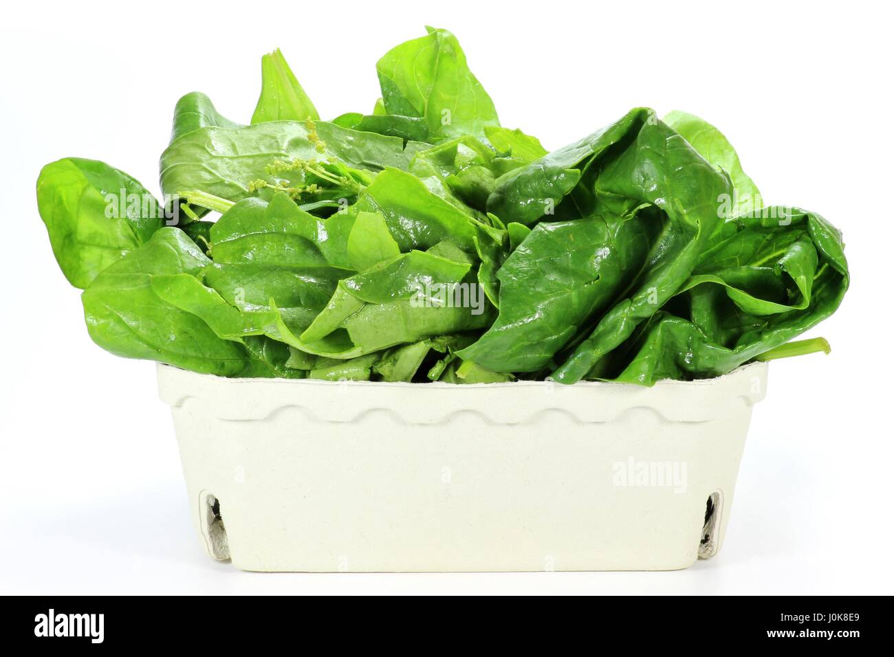 fresh spinach in a cardboard container isolated on white background ...