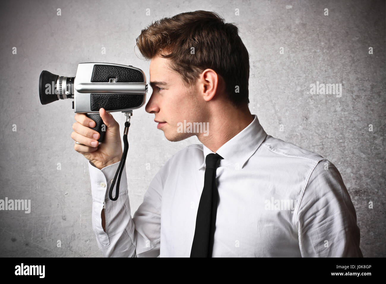 Young man with old video camera Stock Photo - Alamy
