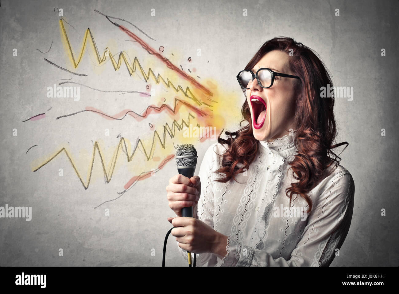 Businesswoman yelling with microphone Stock Photo - Alamy