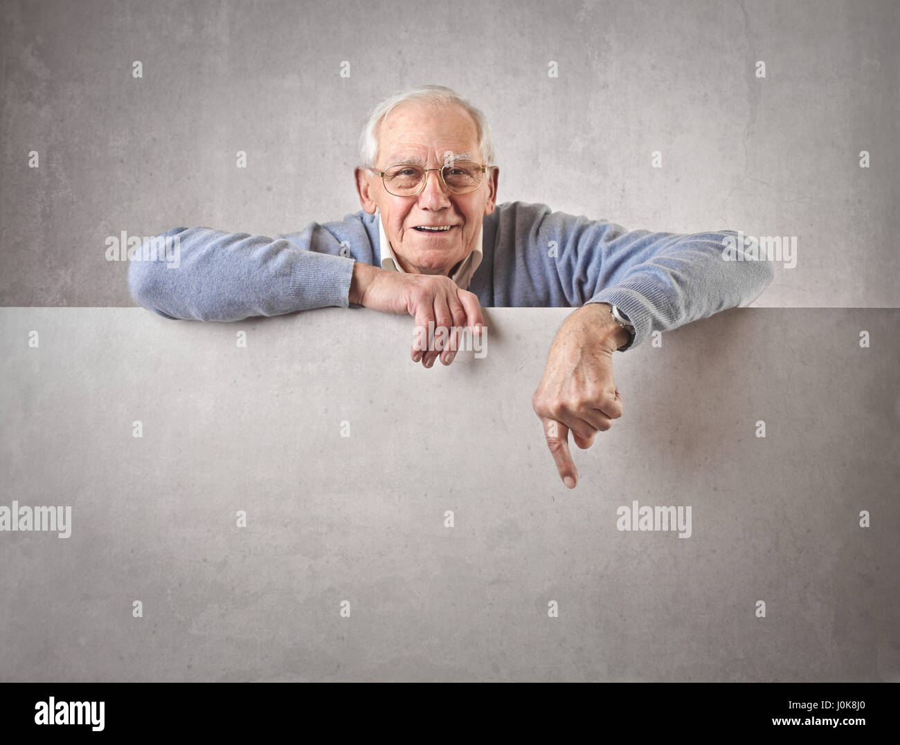 Old man leaning on white board Stock Photo - Alamy
