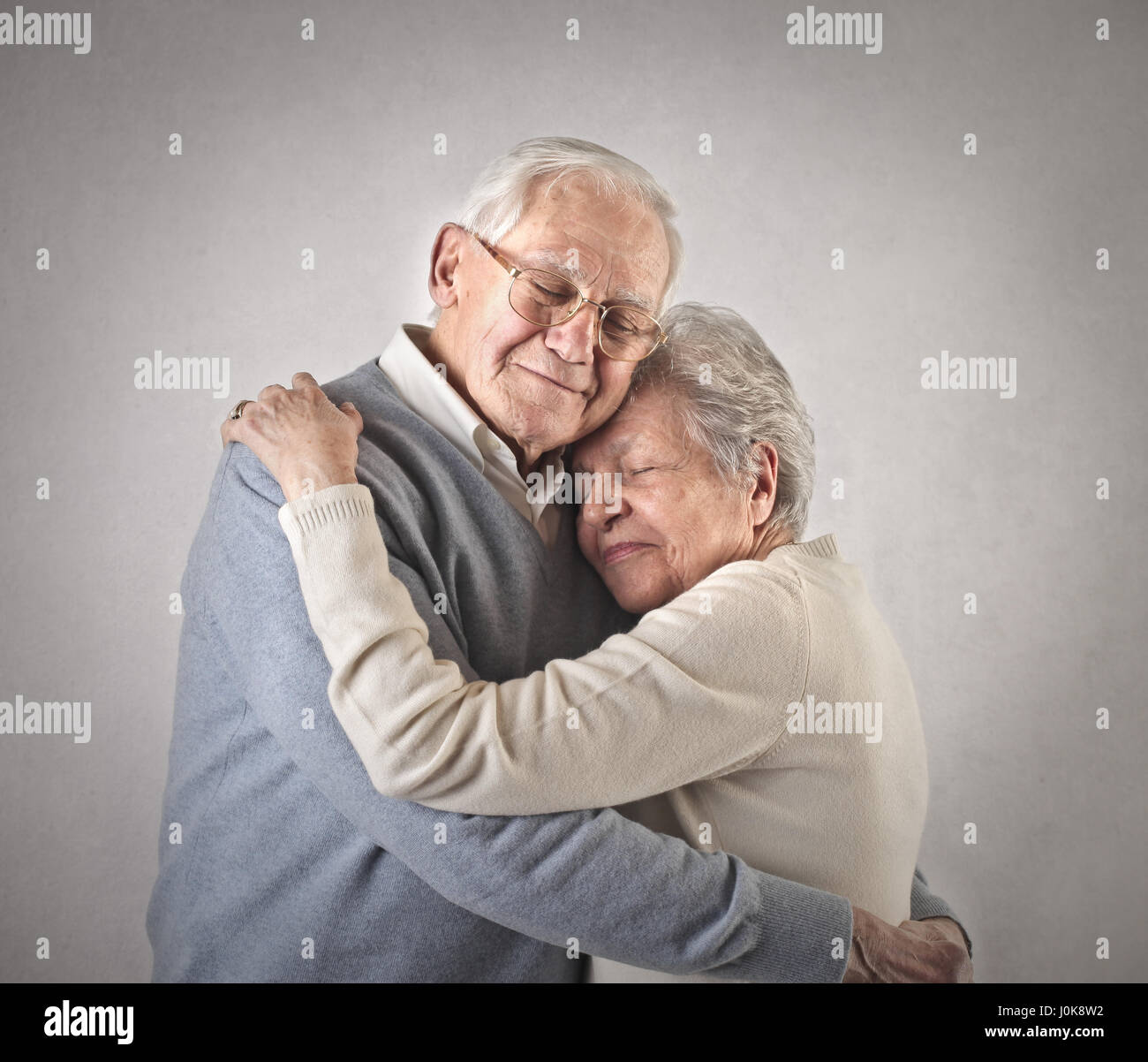 Old couple hugging Stock Photo - Alamy