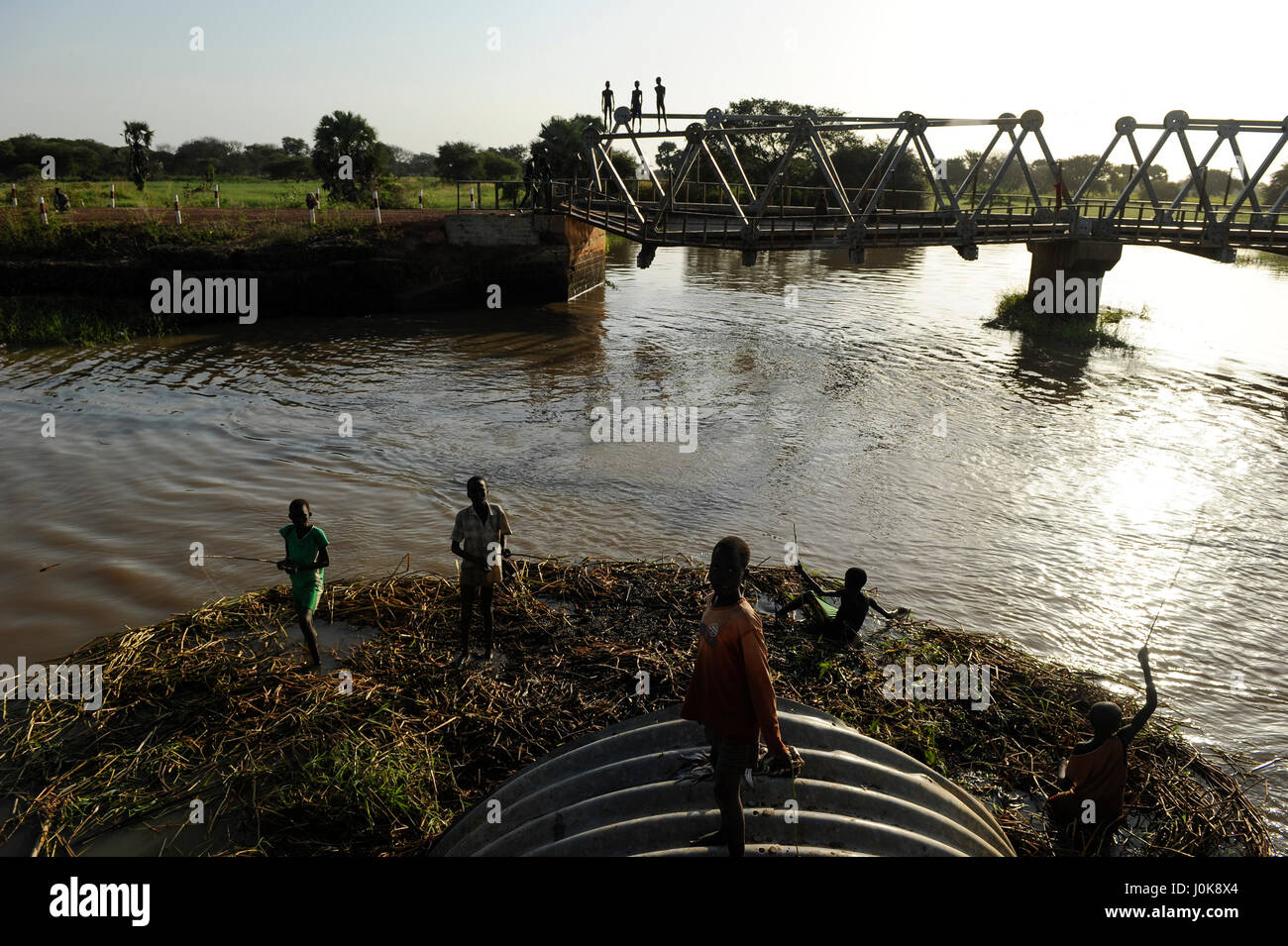 SOUTH SUDAN Lakes state, Rumbek, boys catching fish at Bamam bridge ...