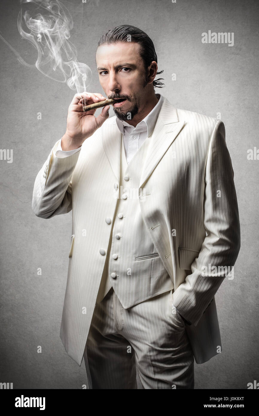 Elegant man smoking cigar Stock Photo - Alamy