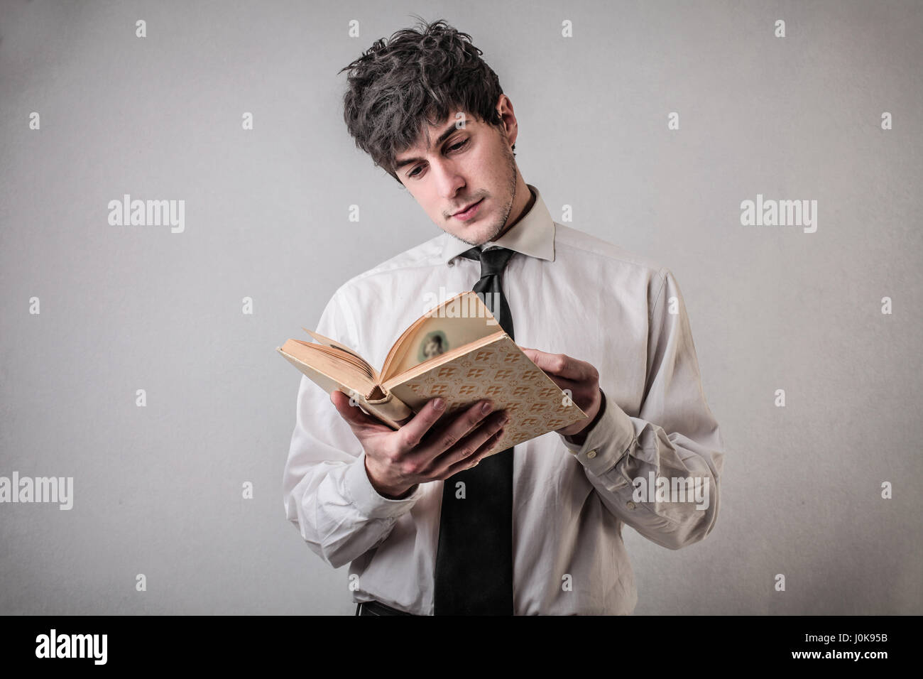 Businessman reading book Stock Photo - Alamy