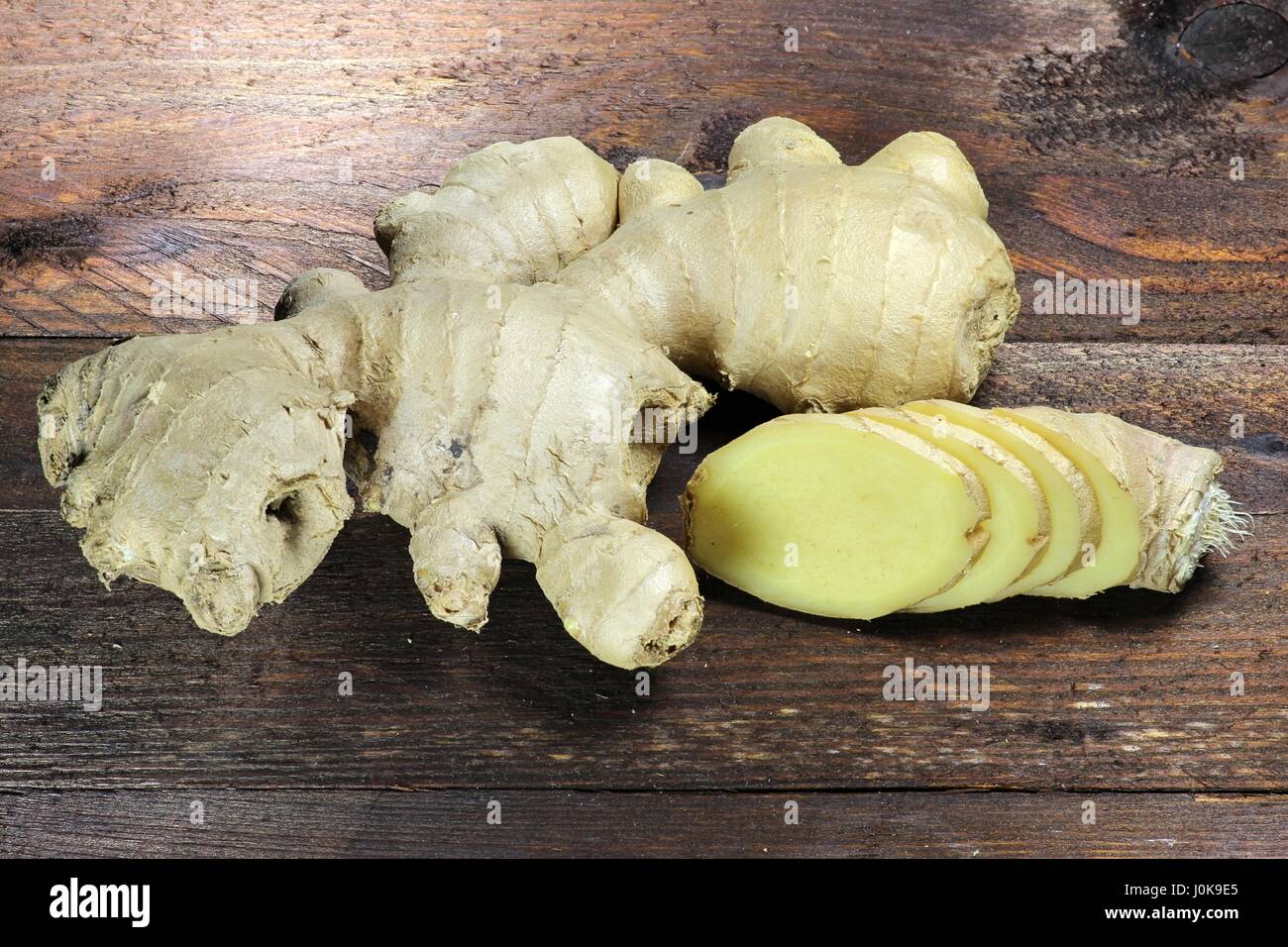 ginger rhizome on wooden background Stock Photo - Alamy
