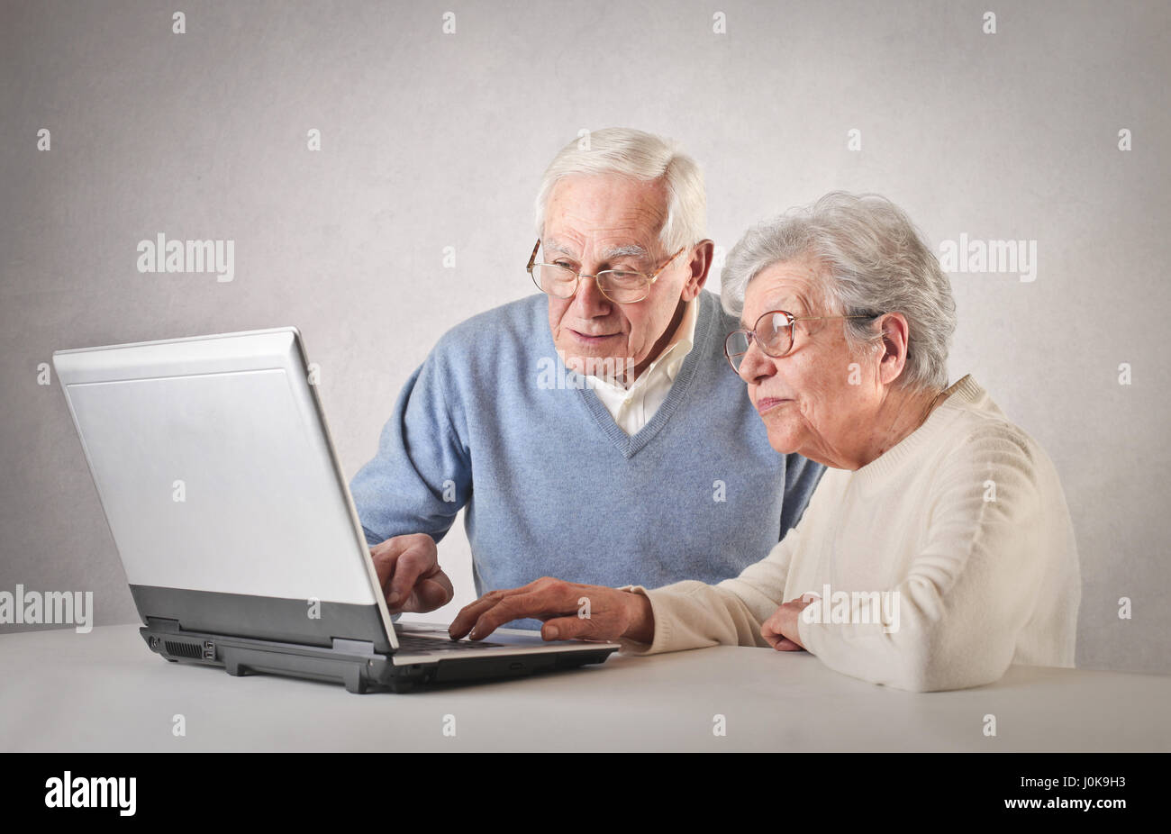 Old couple using laptop together Stock Photo - Alamy