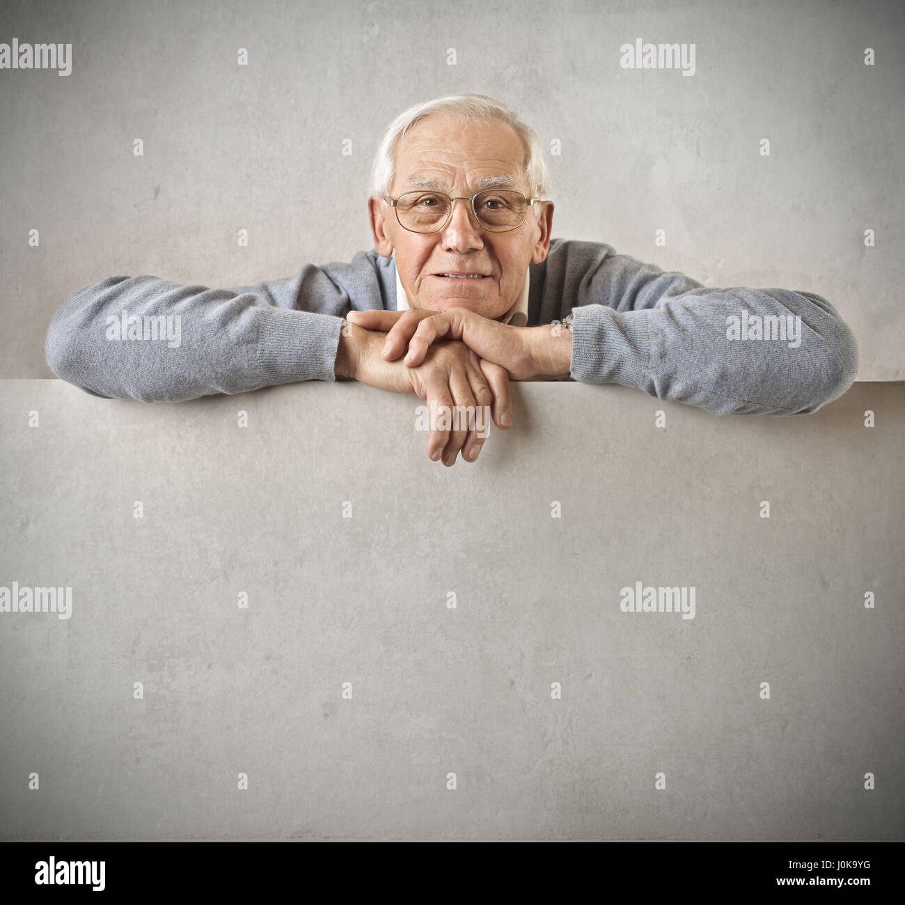 Old man leaning on white board Stock Photo - Alamy