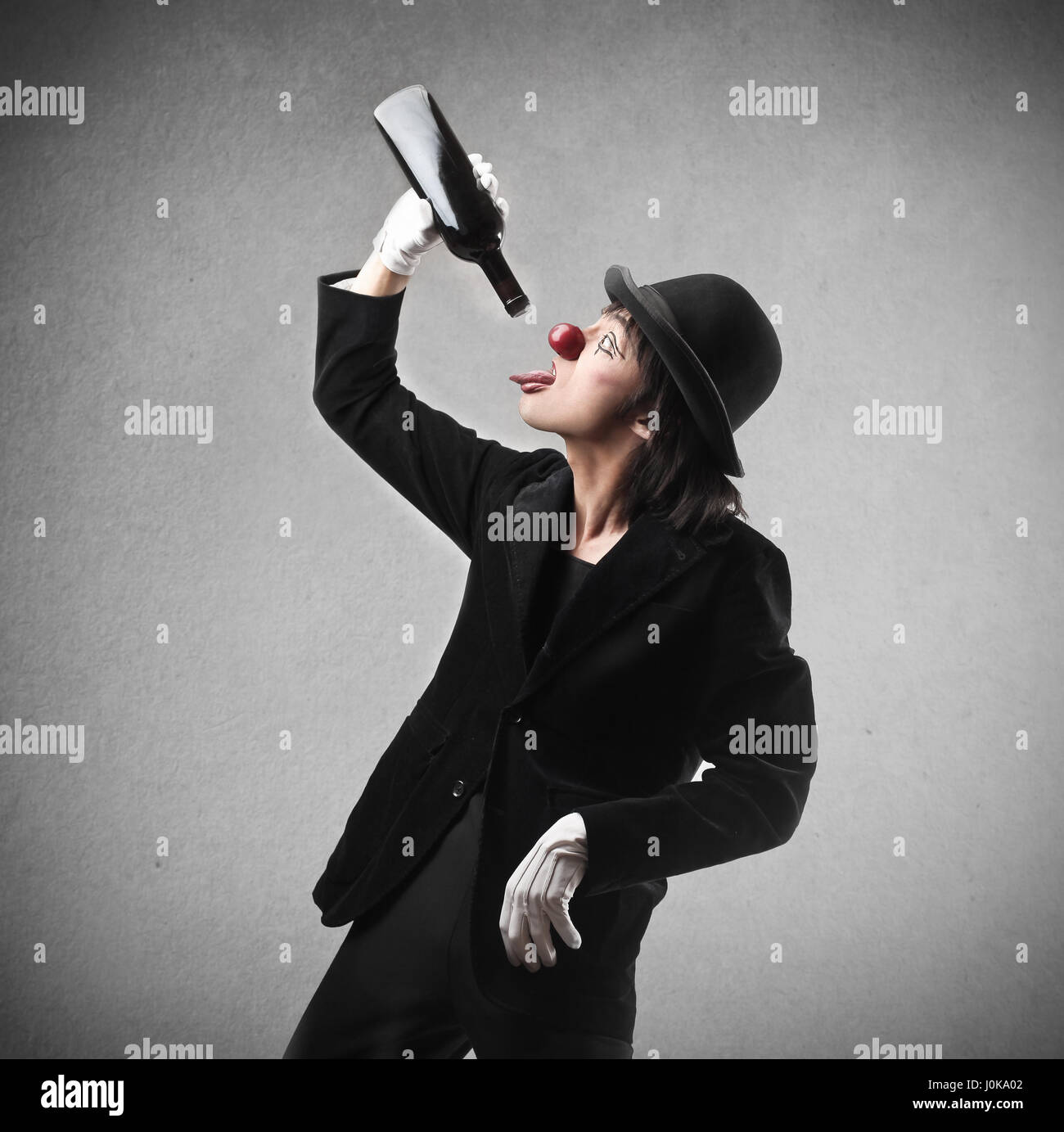 Clown man drinking from bottle Stock Photo - Alamy