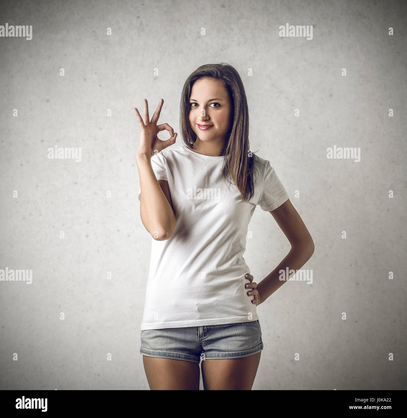 brunette woman showing perfect sign Stock Photo - Alamy