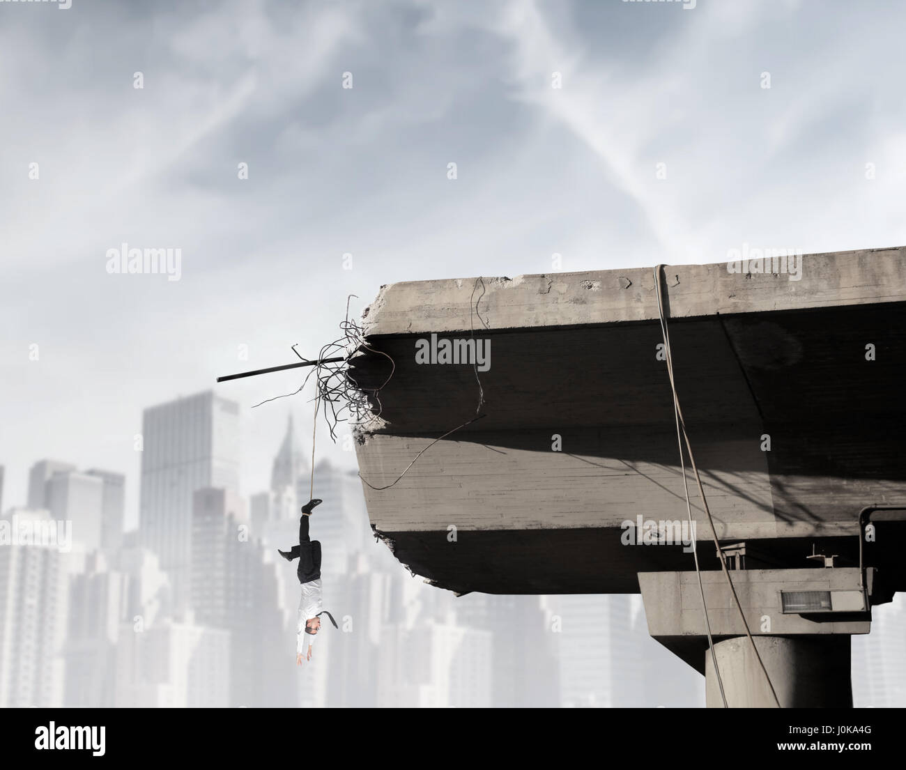 Businessman hanging on building Stock Photo - Alamy