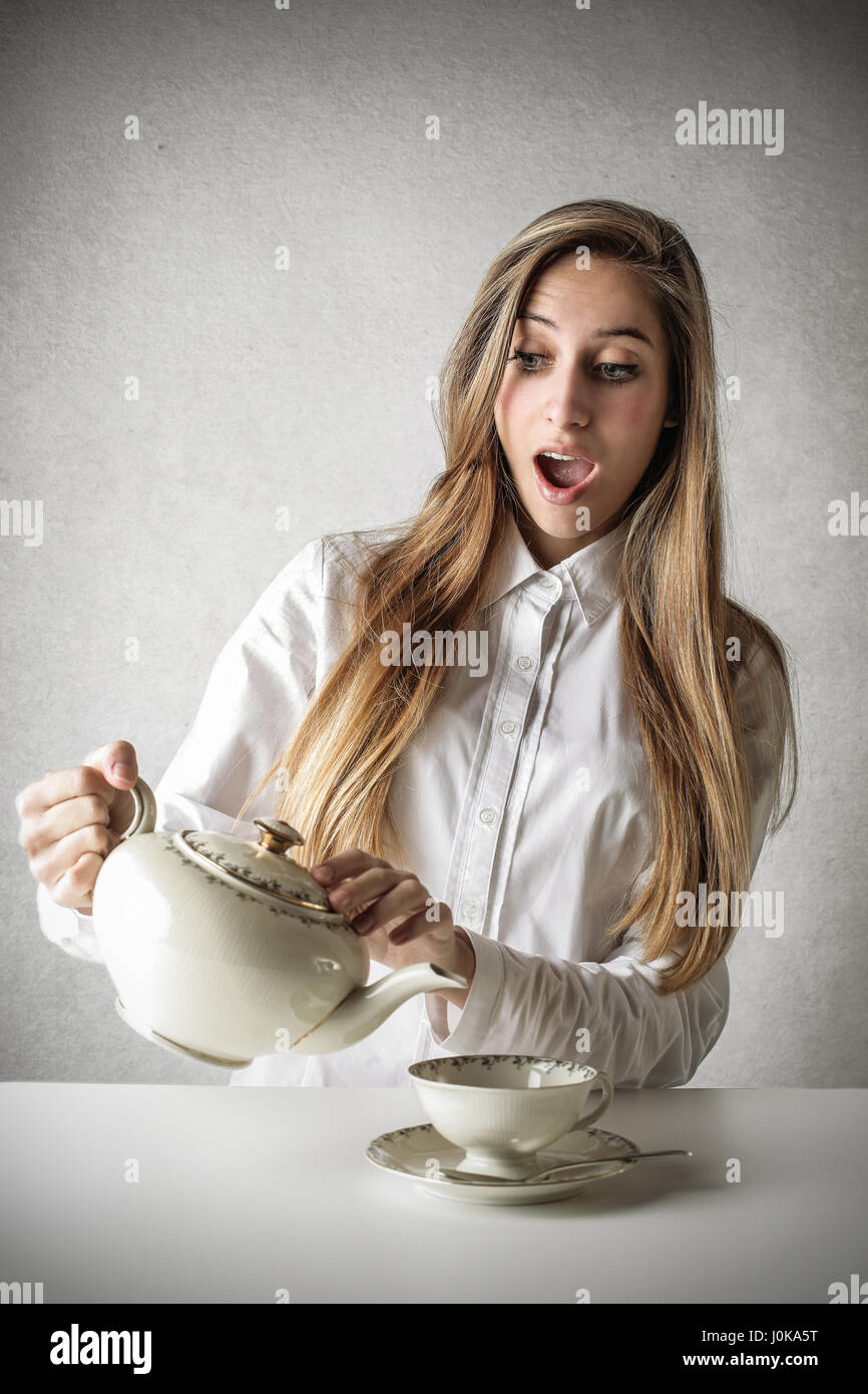 Blond woman pouring out tea Stock Photo - Alamy