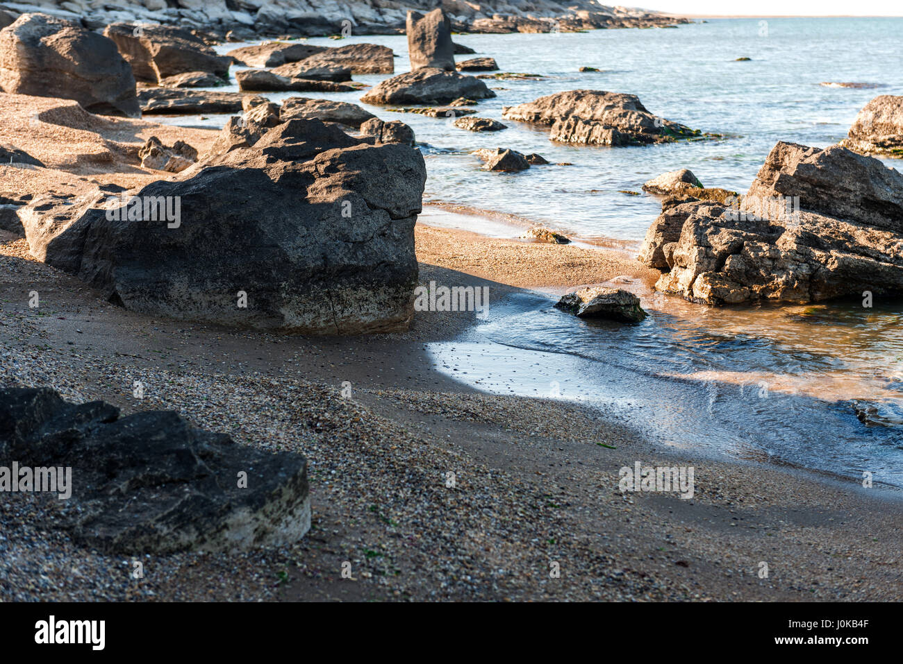 Coast with rocks and blue water Stock Photo - Alamy