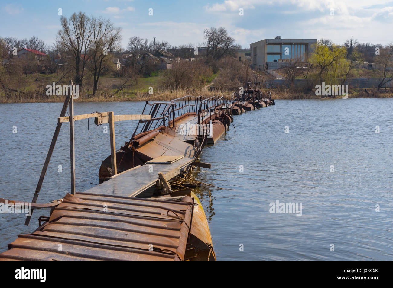 Landscape with pontoon-bridge over small river Sura to remote Ukrainian ...