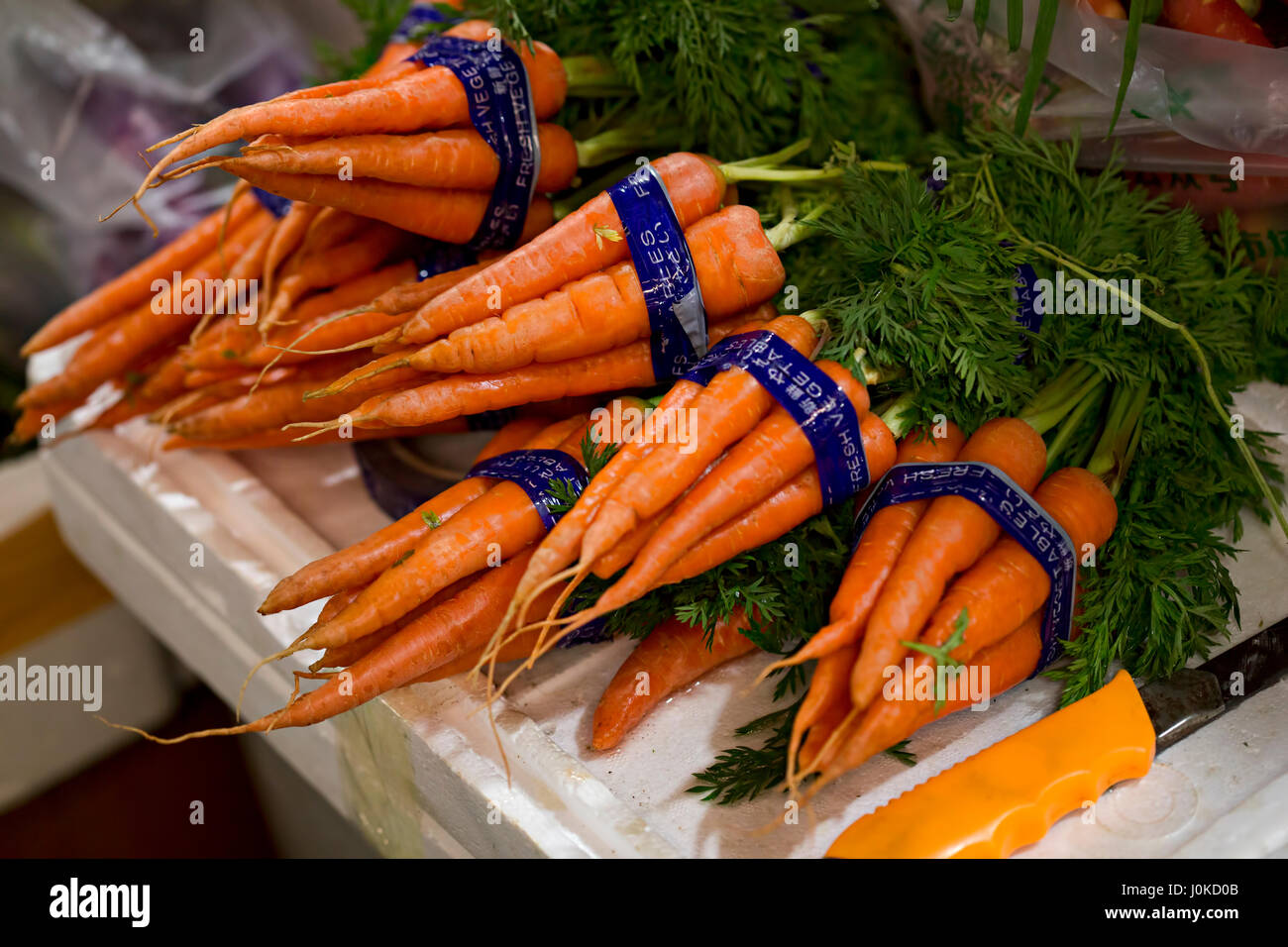 Carrots on asian market Stock Photo - Alamy