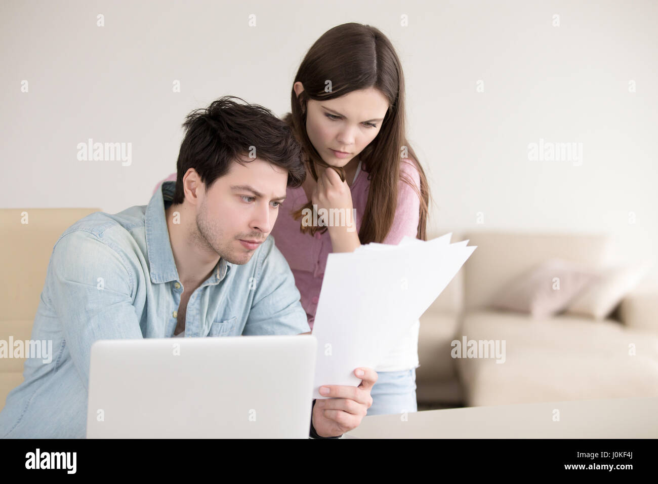 Couple looking at documents, calculating bills, reading letters Stock ...