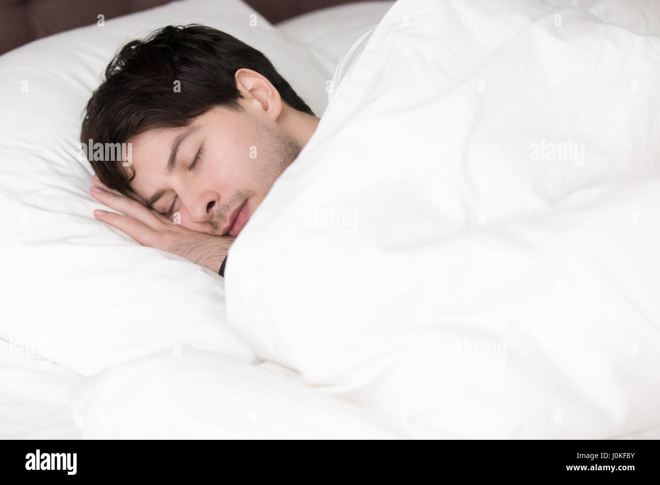 Handsome man sleeping in bed hi-res stock photography and images - Alamy
