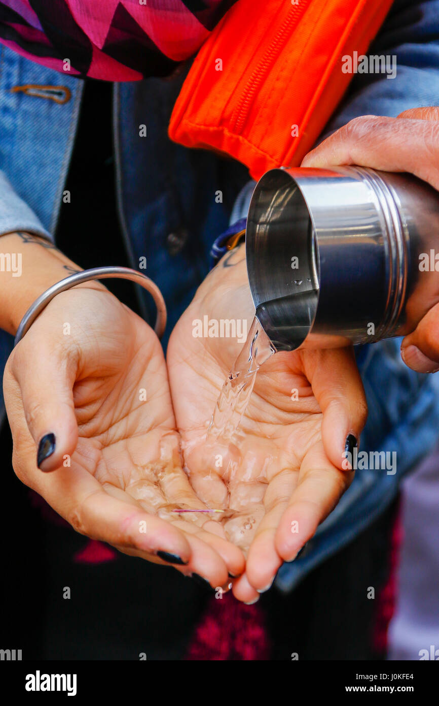Woman having her hands washed as an important cleansing part of the ...