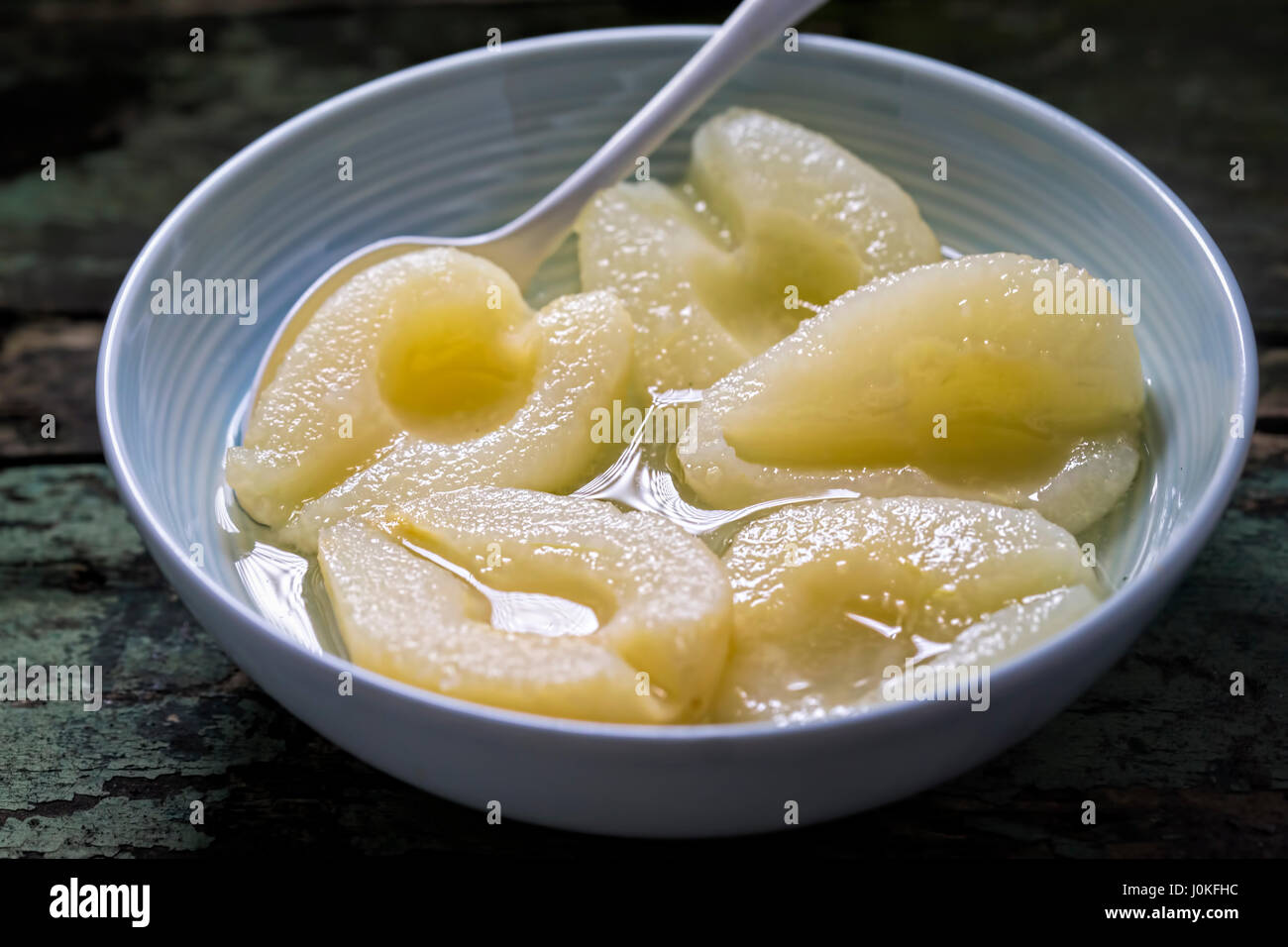 Pear halves syrup bowl Stock Photo - Alamy