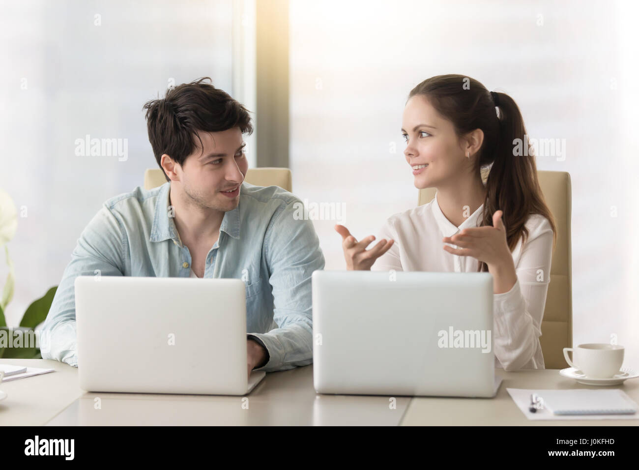 Conversation between two colleagues or business partners sitting Stock ... Conversation between two colleagues or business partners sitting Stock ...