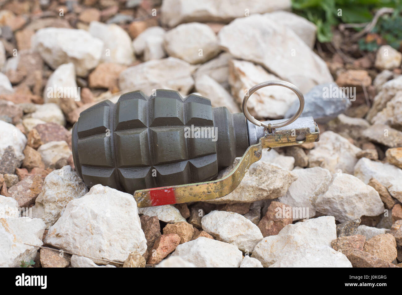 Hand grenade lying on the stones Stock Photo - Alamy