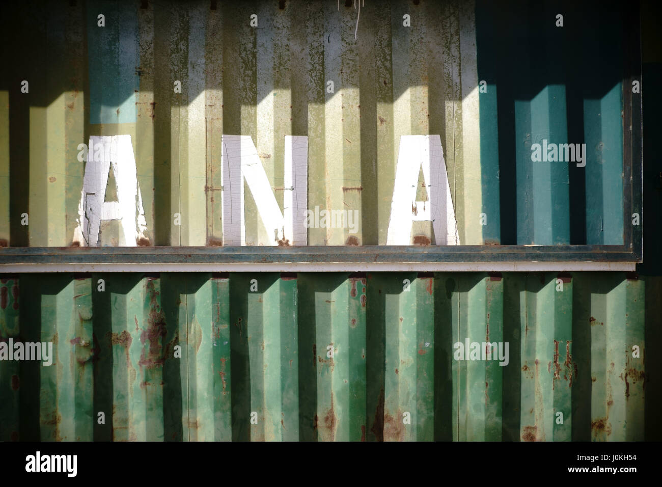 The close-up of the side profile of a metal container with rust stains ...
