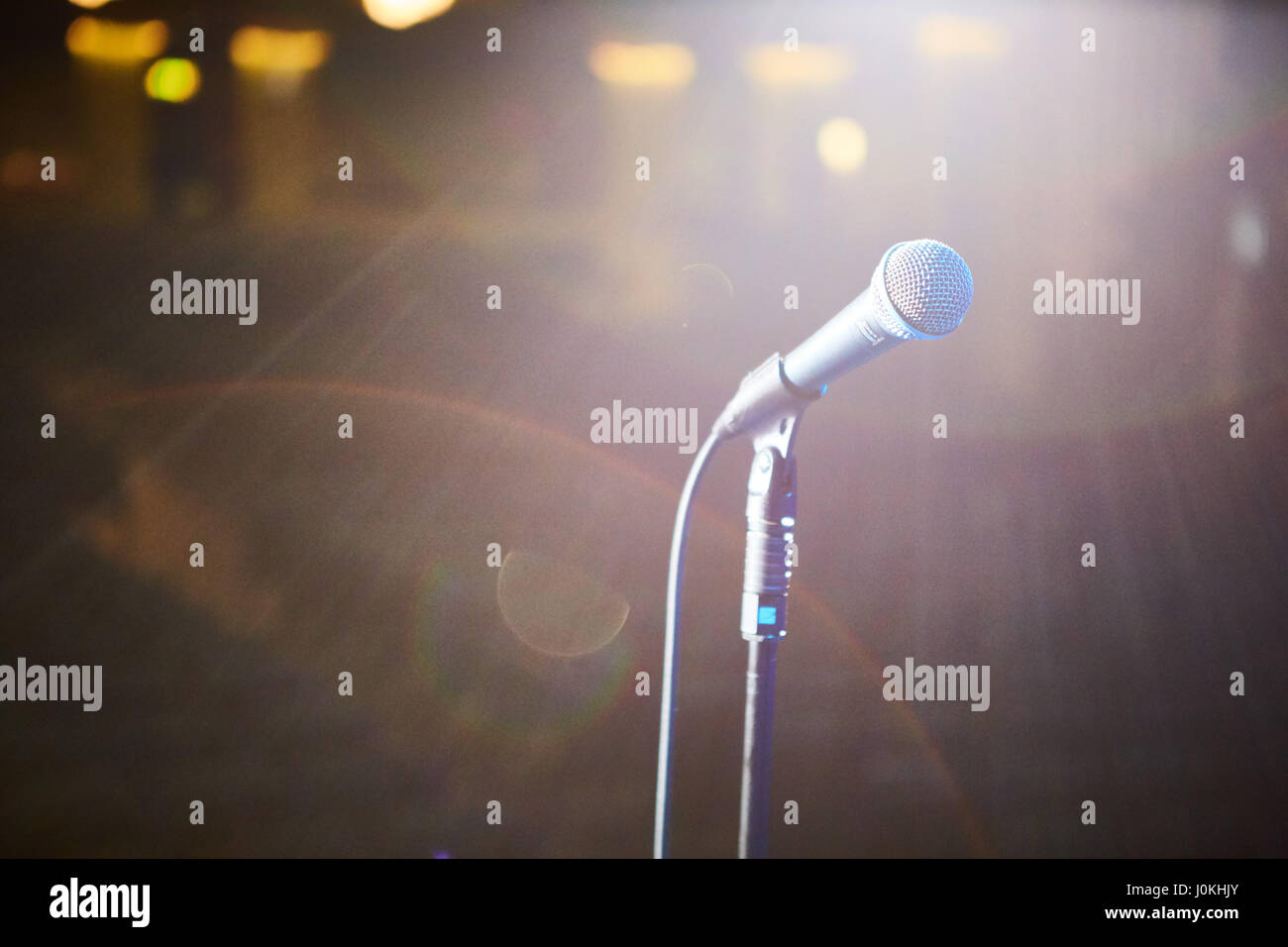 Microphone on stage Stock Photo - Alamy