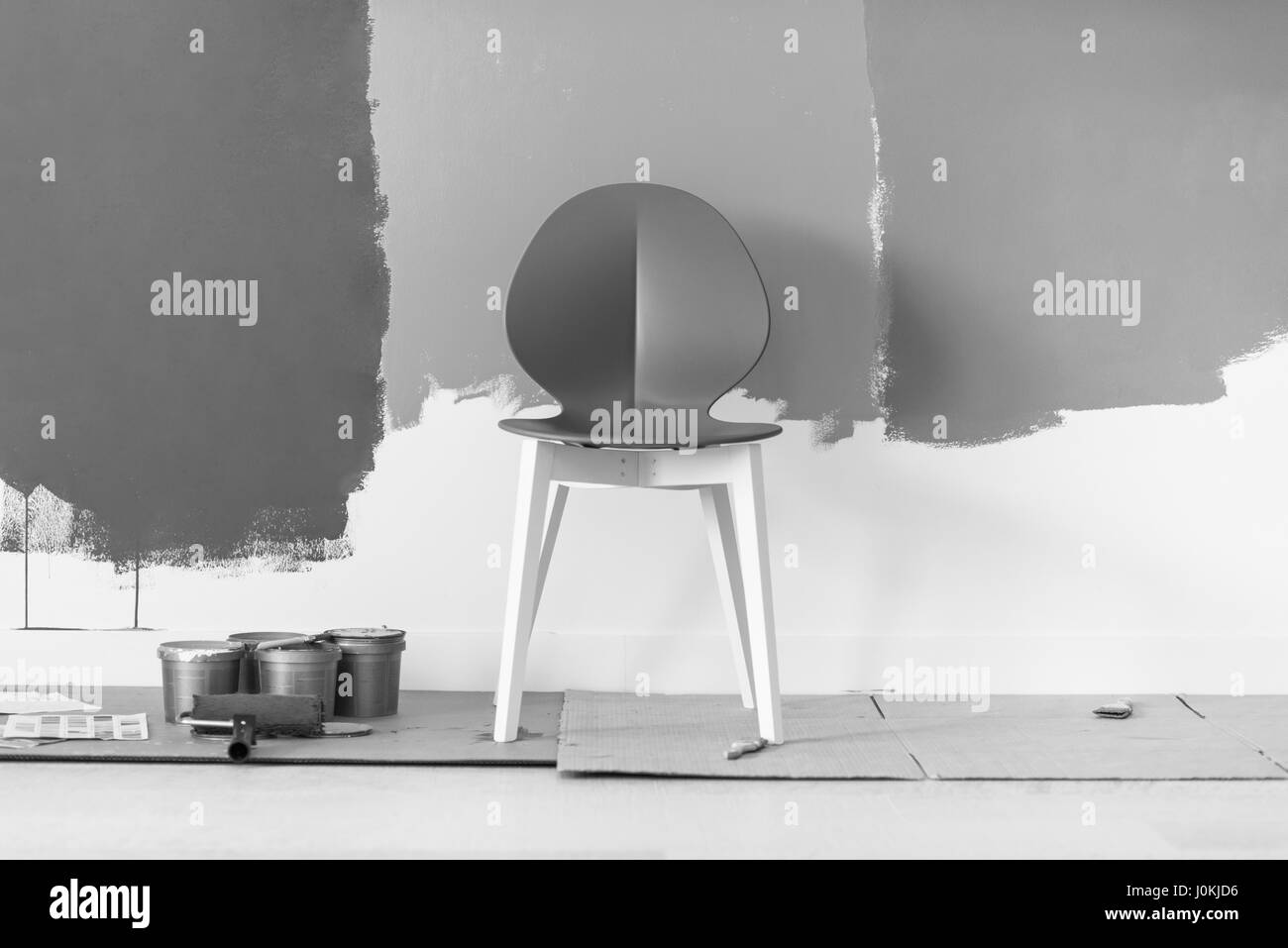 empty chair and equipment for painting in front of colorful wall in the ...