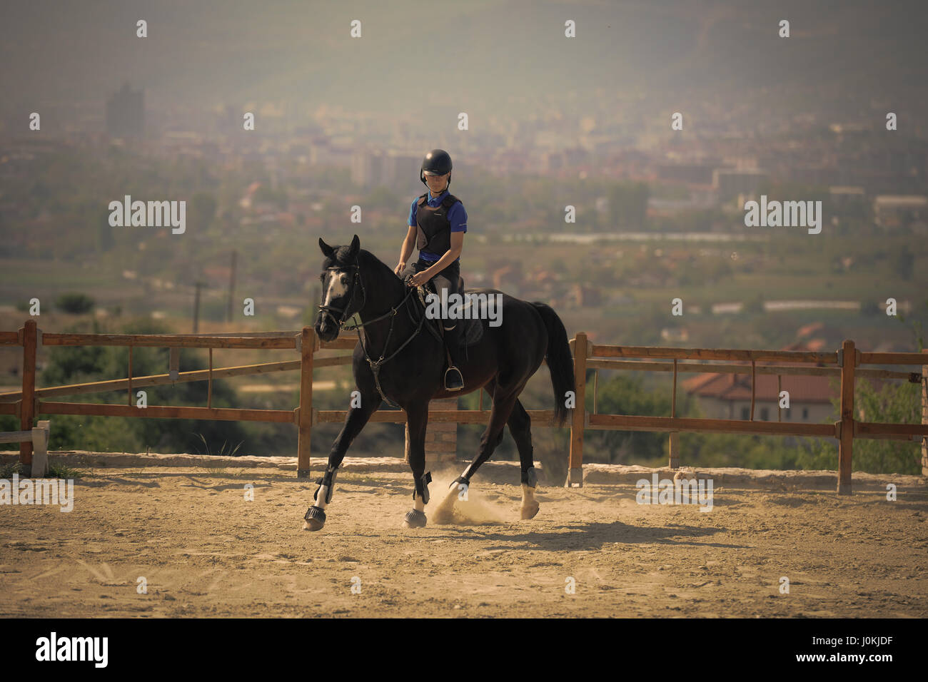 Equestrian sports Black horse approaching. Jockey riding a fast ...