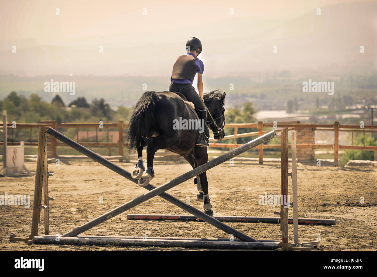 Equestrian sports Black horse approaching. Jockey riding a fast ...