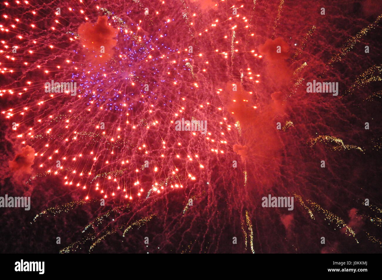 Red colorful fireworks on the black sky background Stock Photo - Alamy
