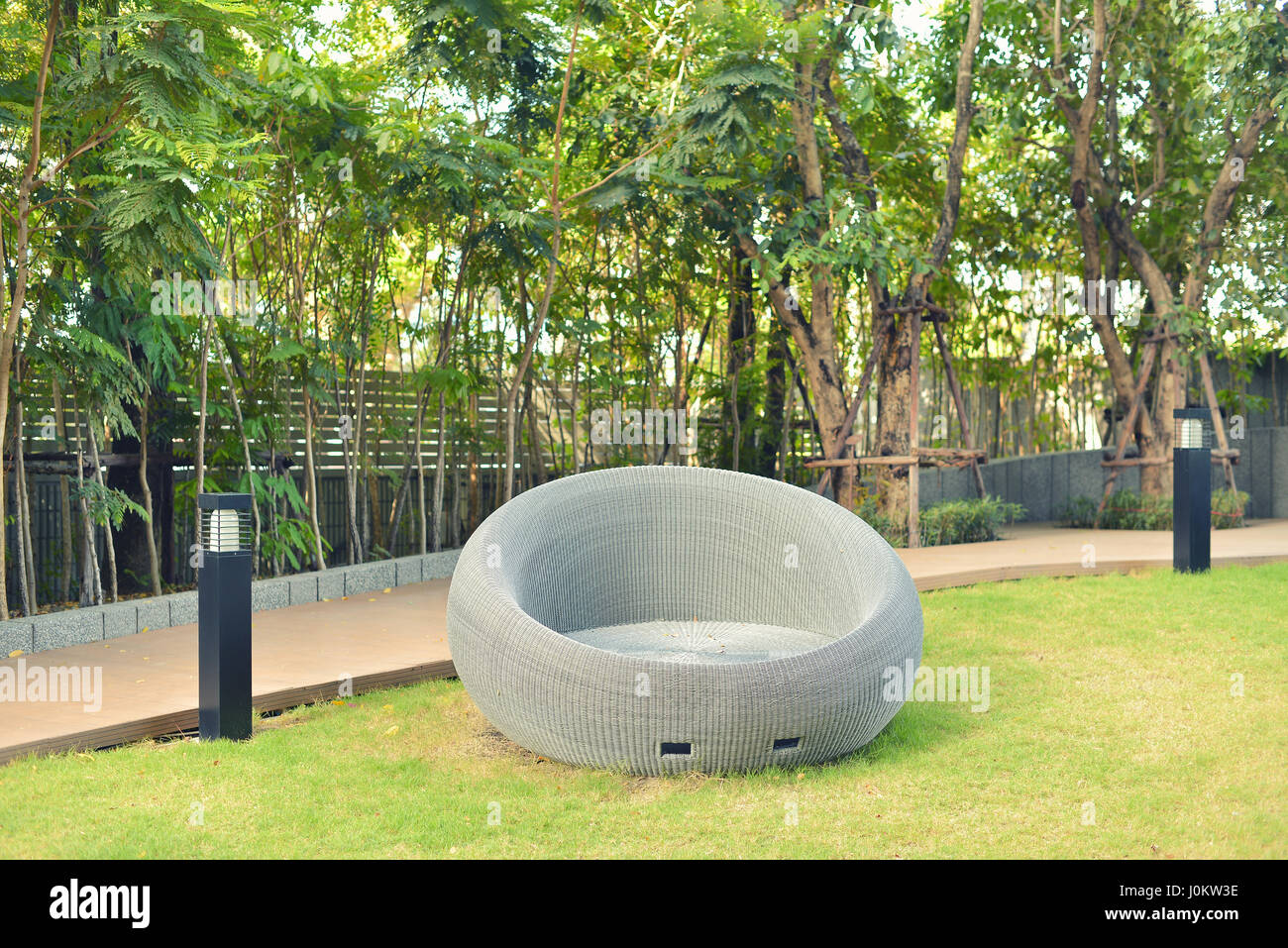 Relaxing Rattan Sofa in a garden, outdoor object Stock Photo - Alamy