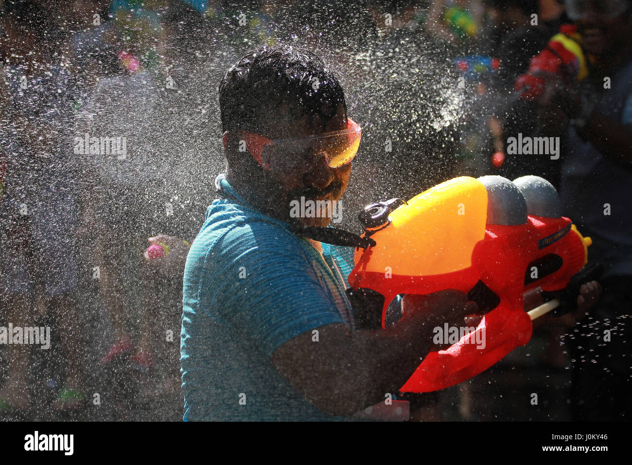 Bangkok, Thailand. 13th Apr, 2017. People use a water gun to take part ...