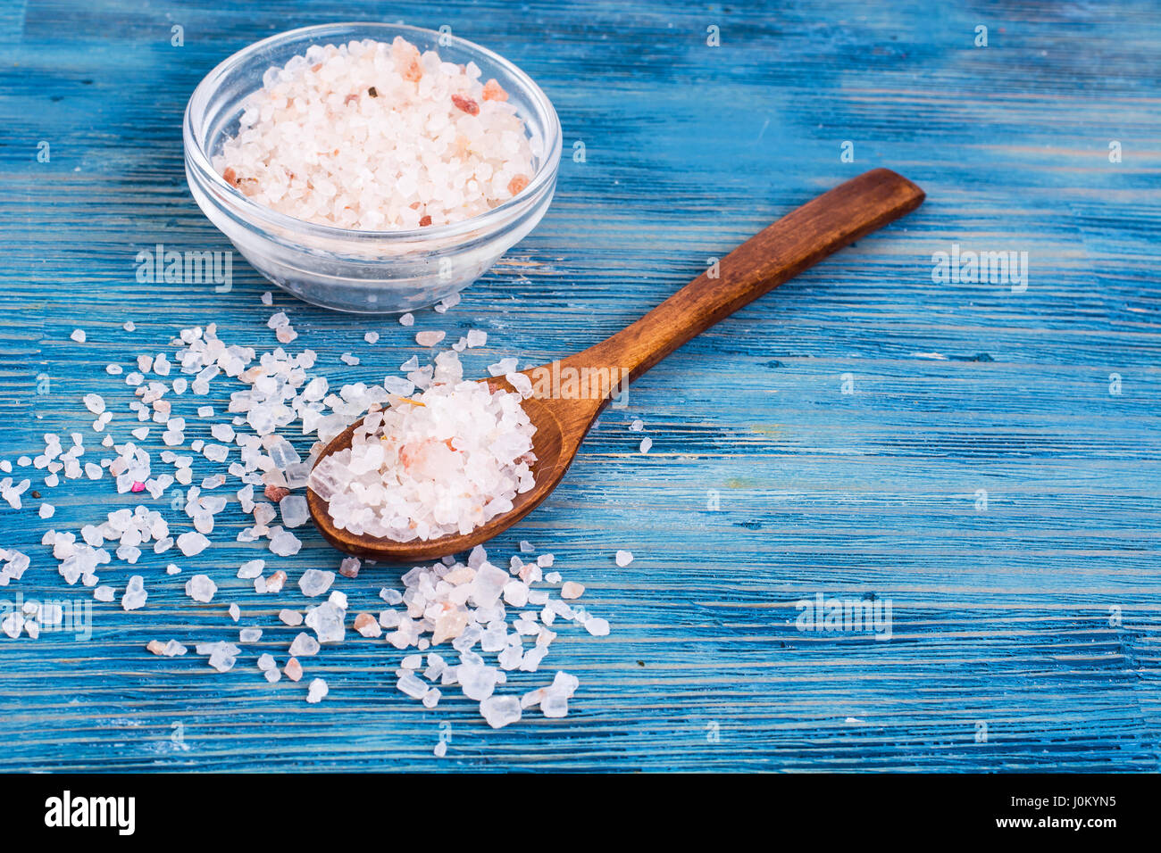 Large pink sea salt on blue background. Studio Photo Stock Photo - Alamy