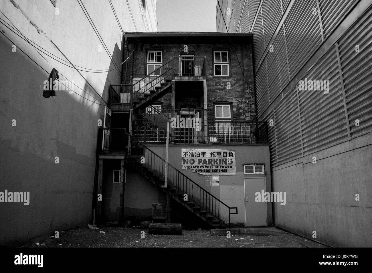 Old brick building squeezed between to concerete buildings Stock Photo ...