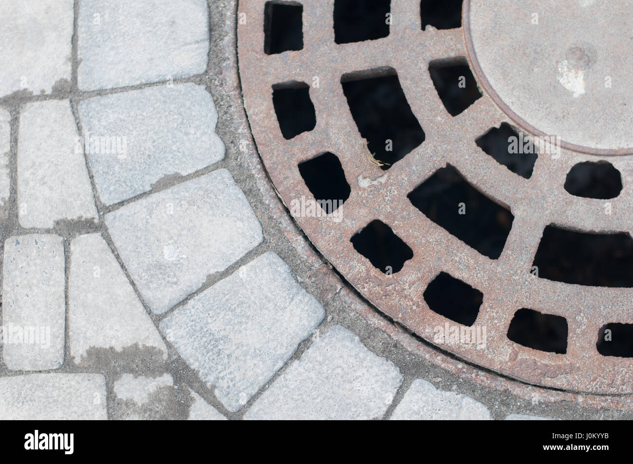 Sewer hatch on ground grey color tile outdoor top view with copy space ...