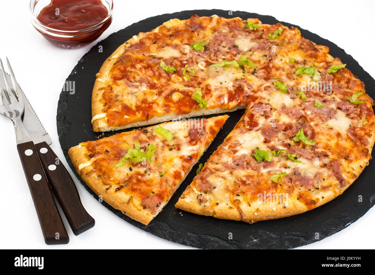 Pizza with ham and cheese on black stone, white background Stock Photo ...